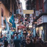 Crowded narrow street in the Quartieri Spagnoli neighborhood of Naples with colorful market stalls