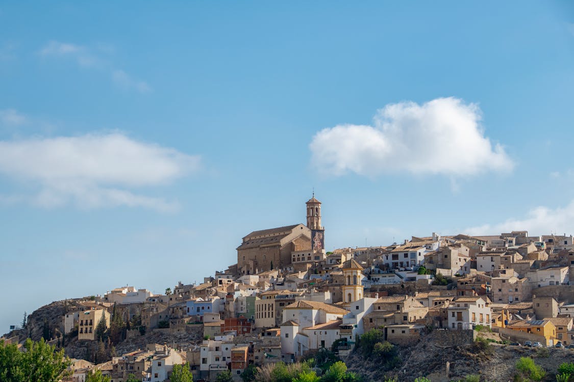 Picturesque Spanish village buildings with terracotta roofs on a sunny day