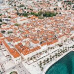 Aerial view of Split old town with red roofs and turquoise Adriatic Sea