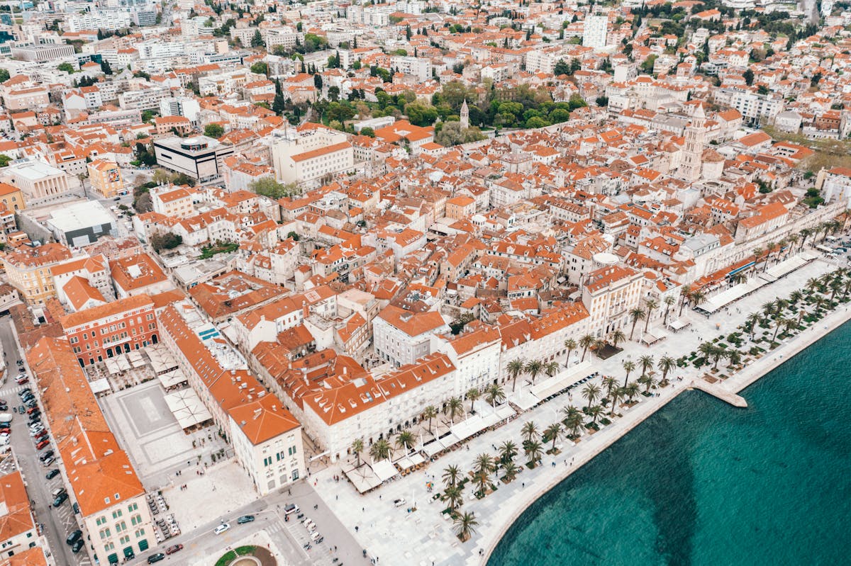 Aerial view of Split old town with red roofs and turquoise Adriatic Sea