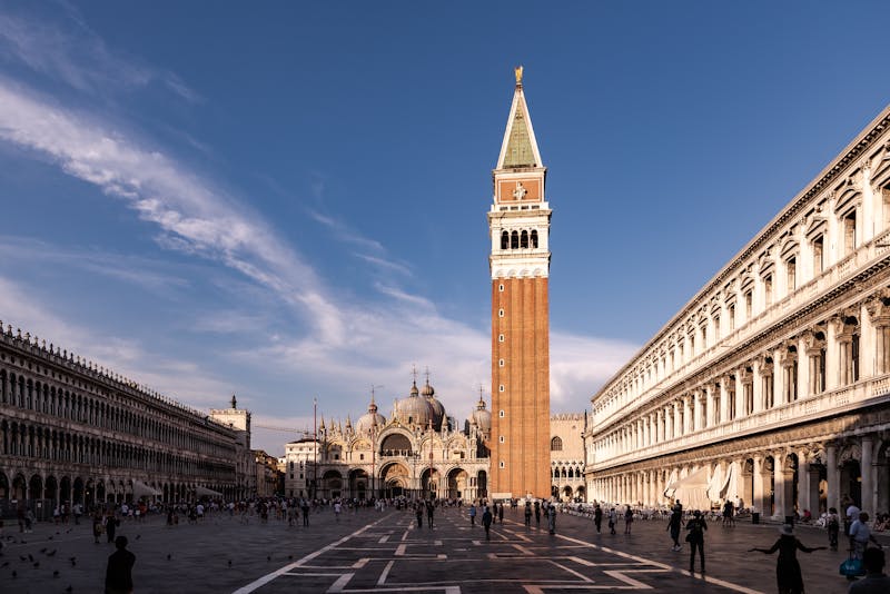 Clear day view of St Marks Square showing the basilica facade and tall campanile bell tower