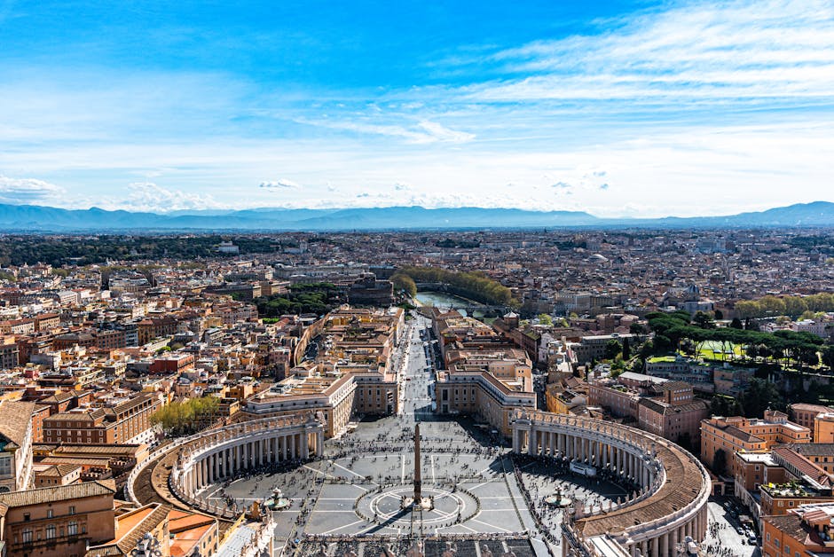 Aerial view of St Peters Square with its iconic colonnade and central obelisk in Vatican City
