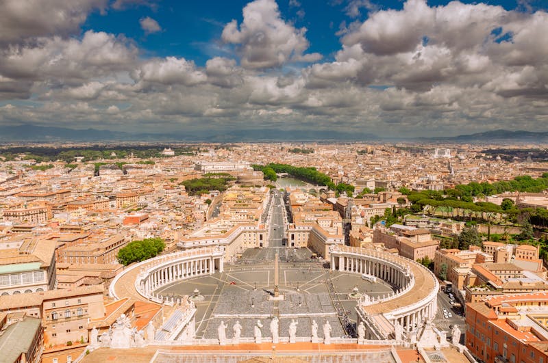 Stunning aerial view of Vatican City showing St Peters Square colonnade and surrounding Roman streets