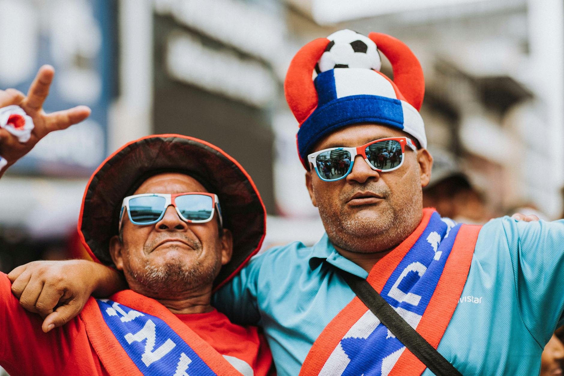 Two excited football fans celebrating outdoors