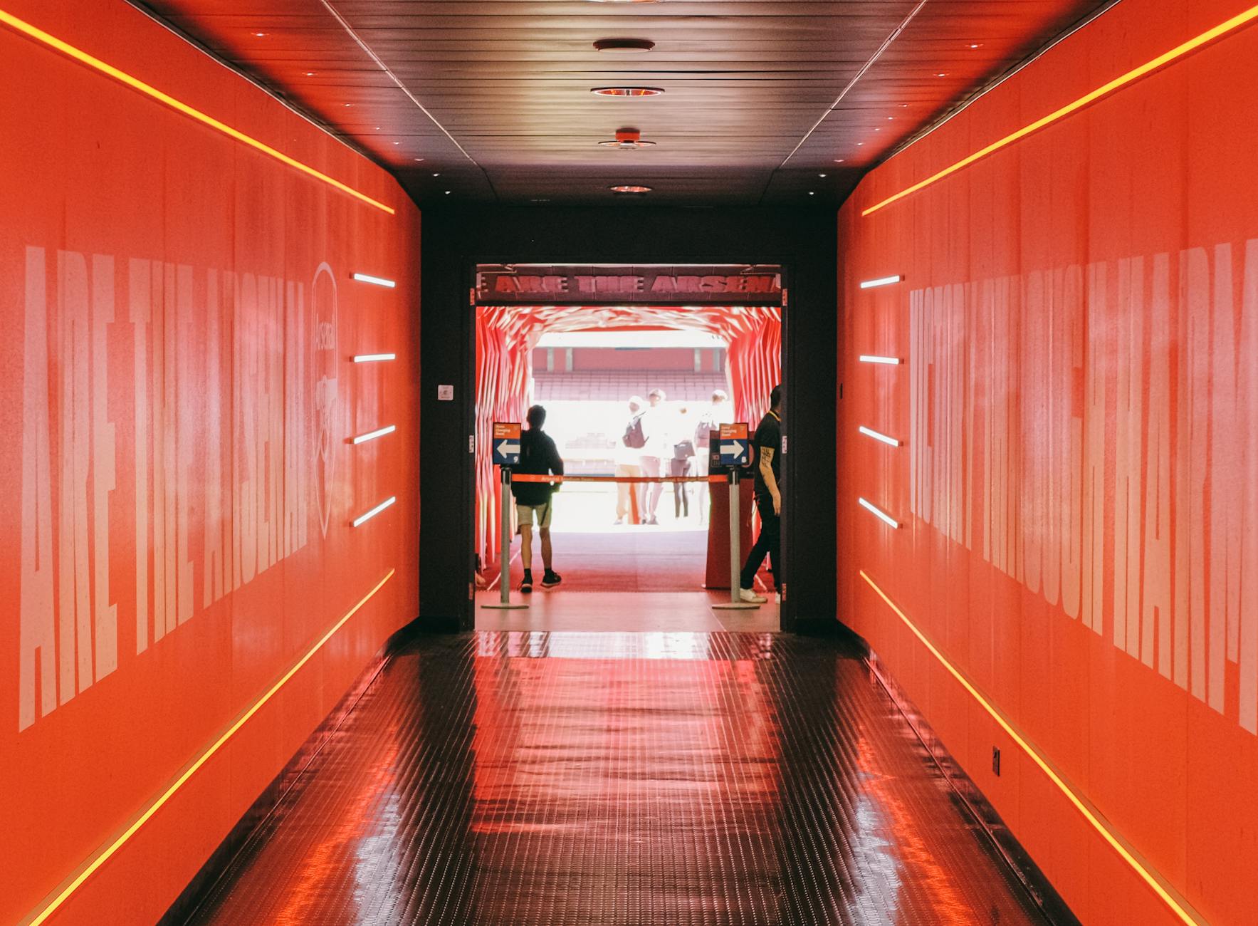 Red tunnel leading to Emirates Stadium pitch