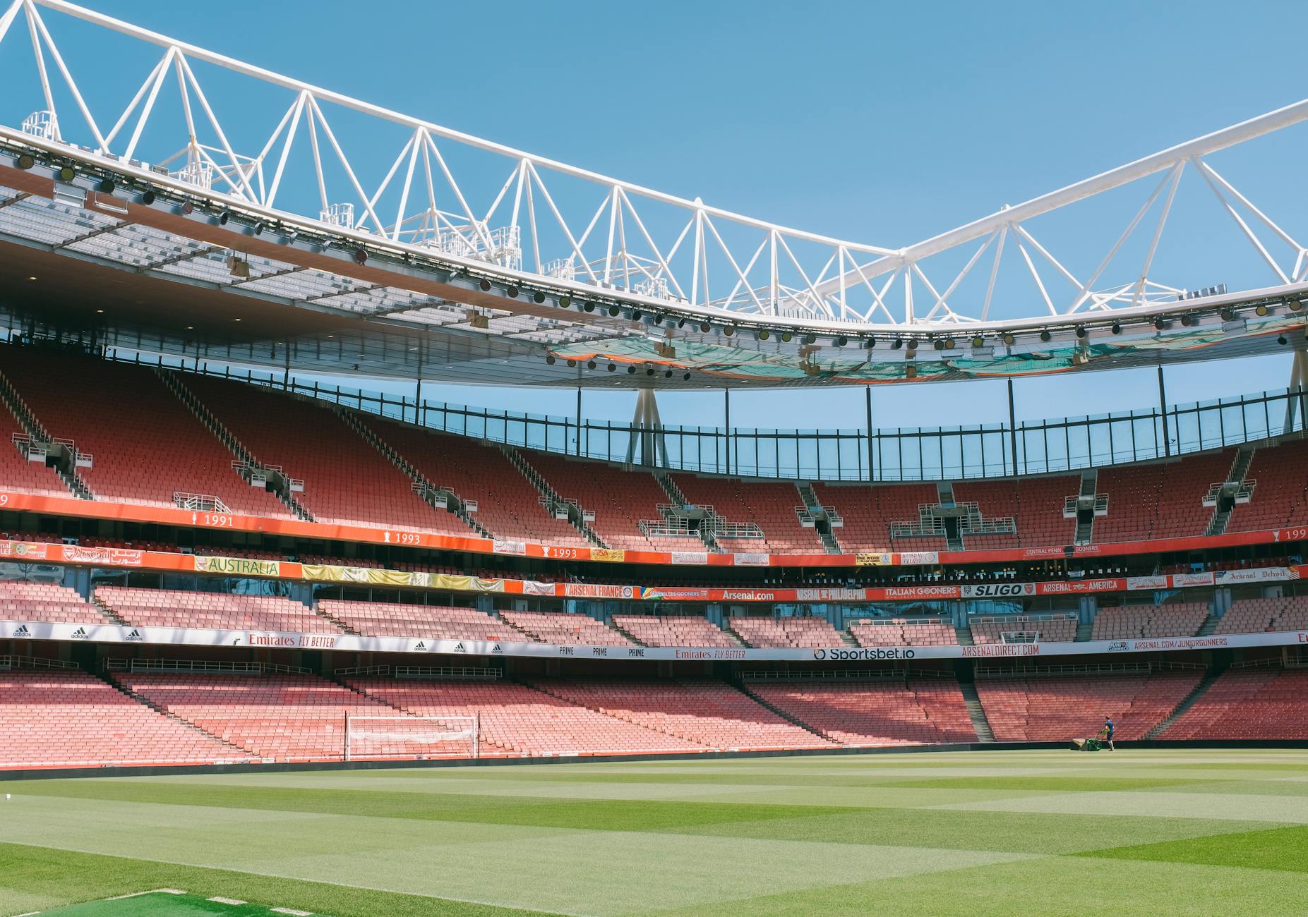 Emirates Stadium empty stands under clear blue sky