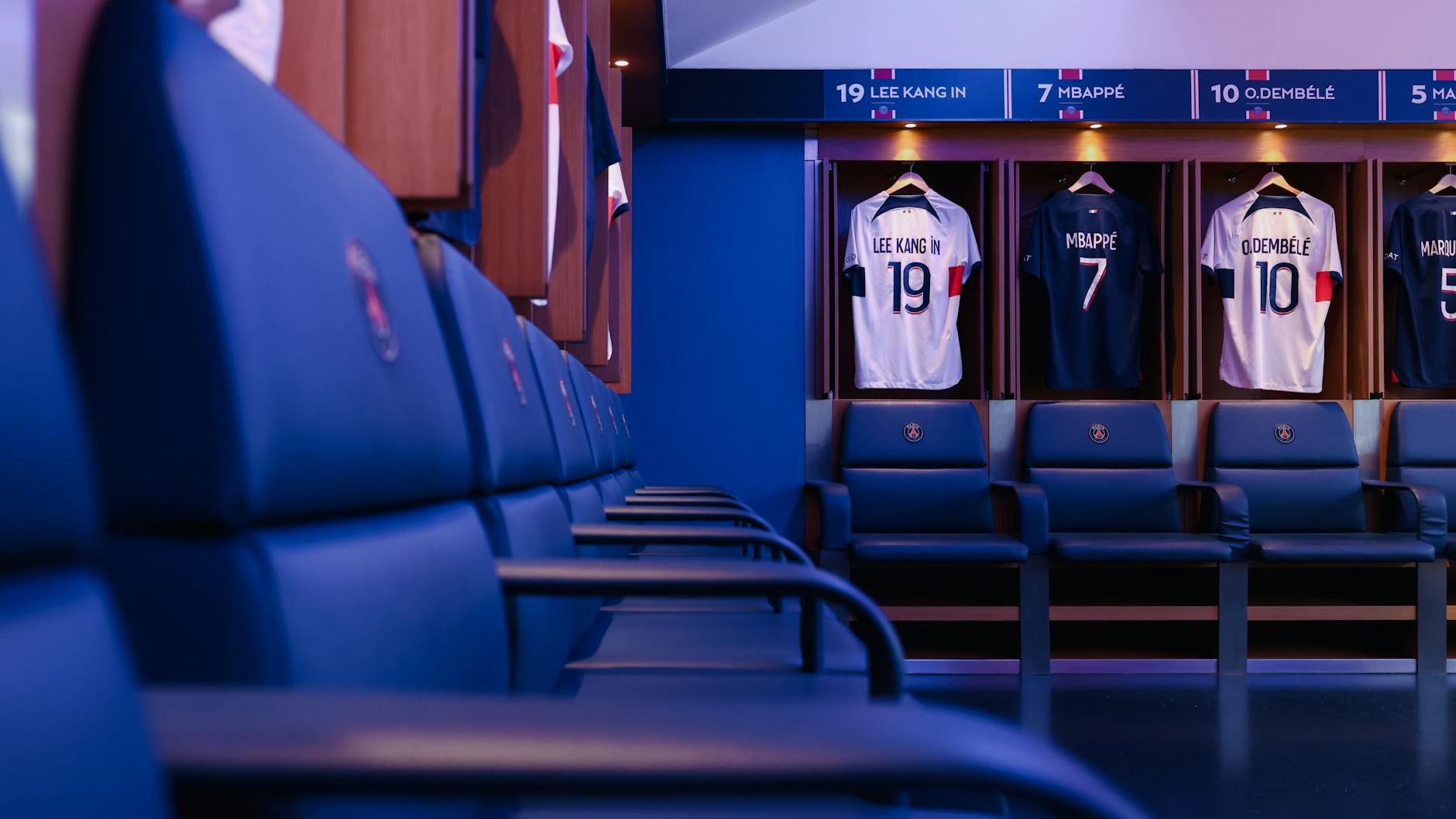 Professional football locker room with player jerseys