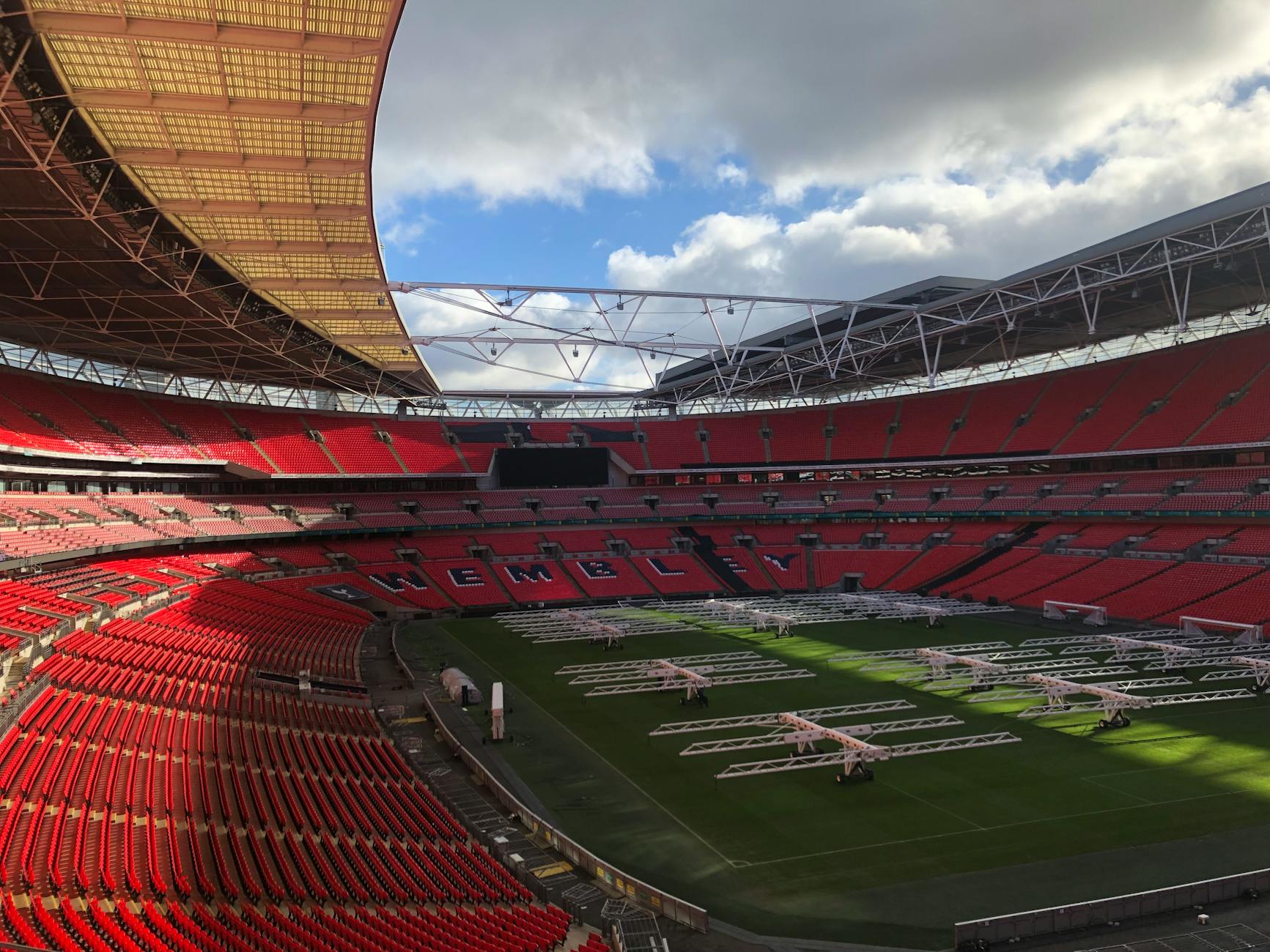 Empty Wembley Stadium under dramatic clouds