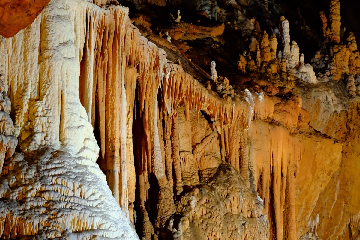 Detailed close-up view of stalactite and stalagmite formations inside a cave
