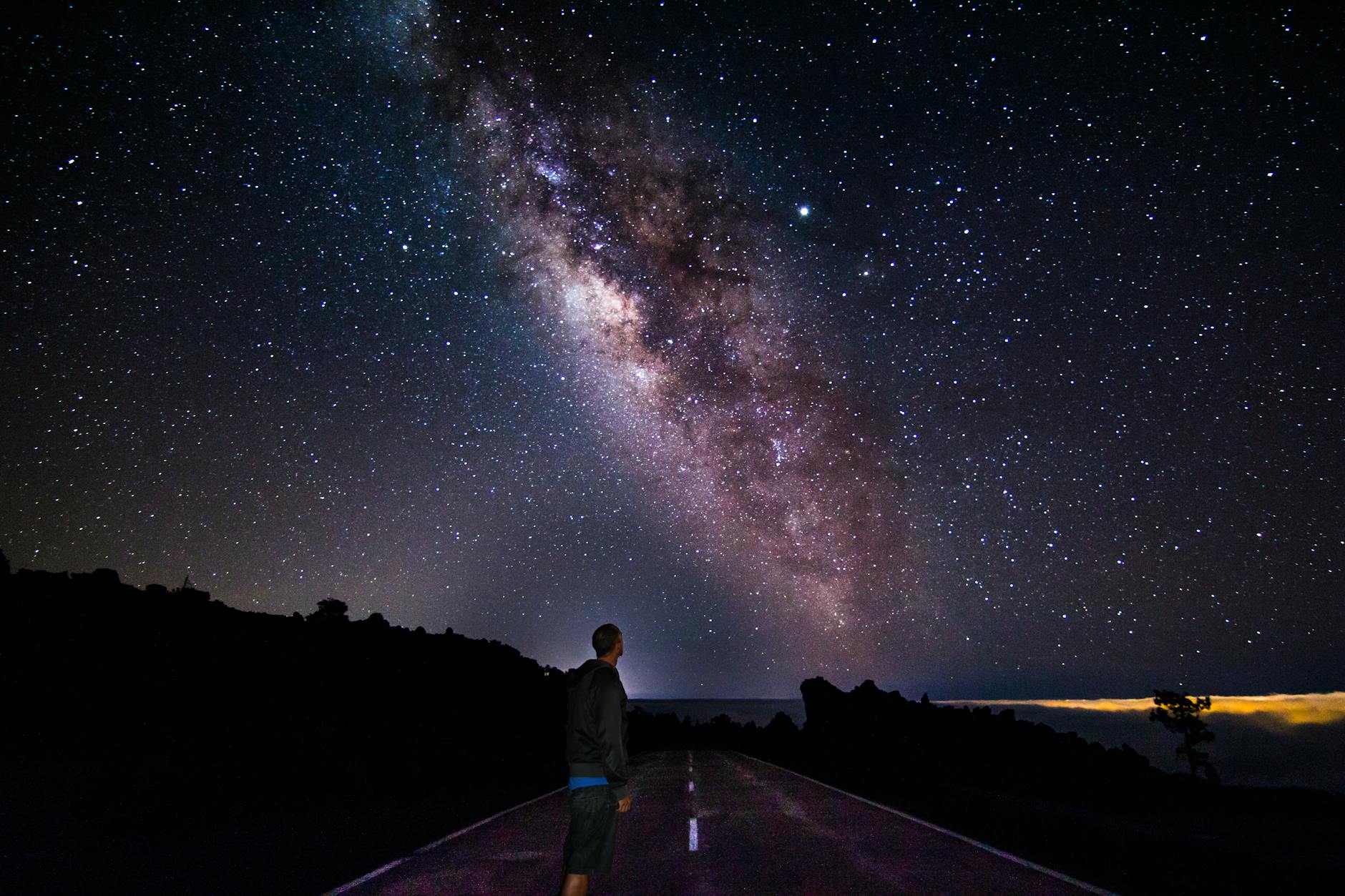Person stargazing under the night sky in Tenerife