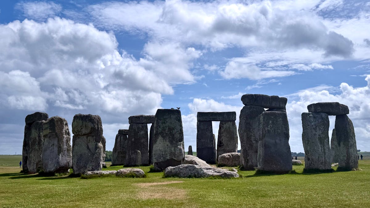 Stonehenge stone pillars photographed against a colourful sky