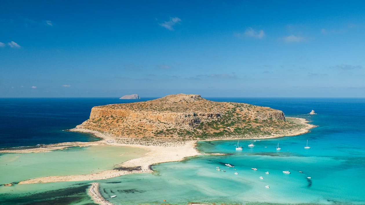 Stunning aerial shot of Balos Lagoon featuring turquoise waters and sandy beaches under a clear sky.