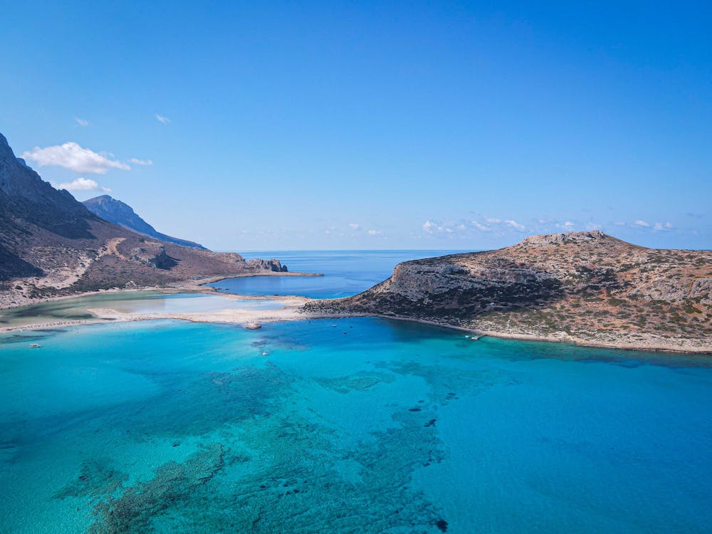 Stunning aerial view of Balos Lagoon with crystal-clear azure waters and serene coastal scenery.