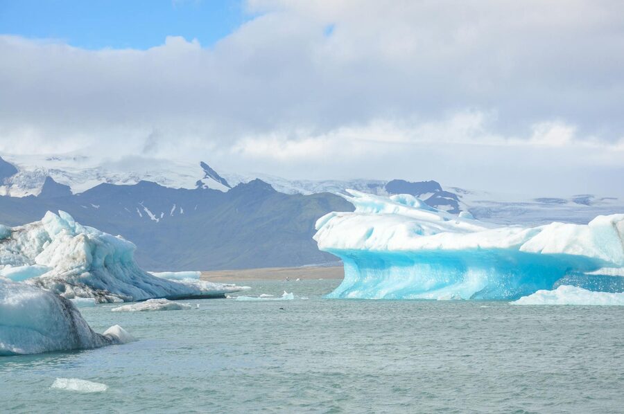 Stunning icebergs floating in Iceland's Jökulsárlón Glacier Lagoon on a clear day.