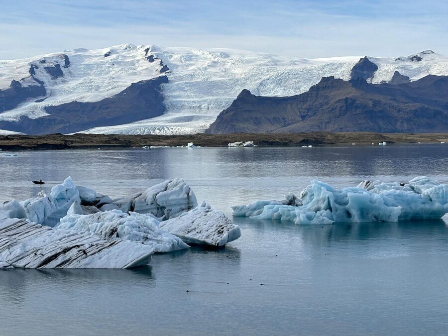Stunning icy panorama of Jokulsarlon Glacier Lagoon in Iceland with floating icebergs and tranquil w
