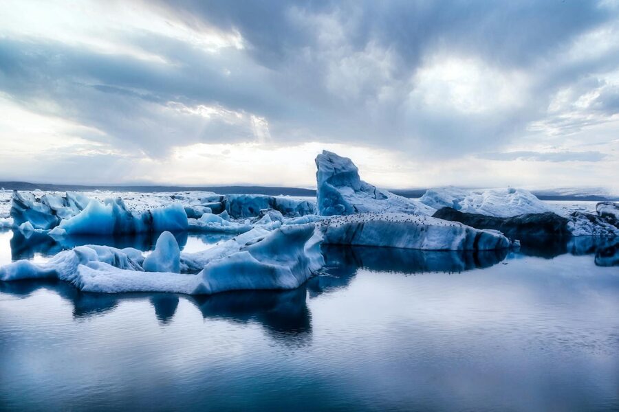 Stunning view of icebergs floating on Jökulsárlón Glacier Lagoon in Iceland's striking landscape.