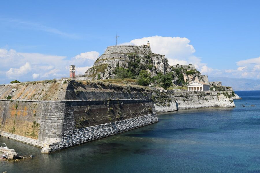 Stunning view of the Old Fortress in Corfu, Greece with a backdrop of the ocean and sky.