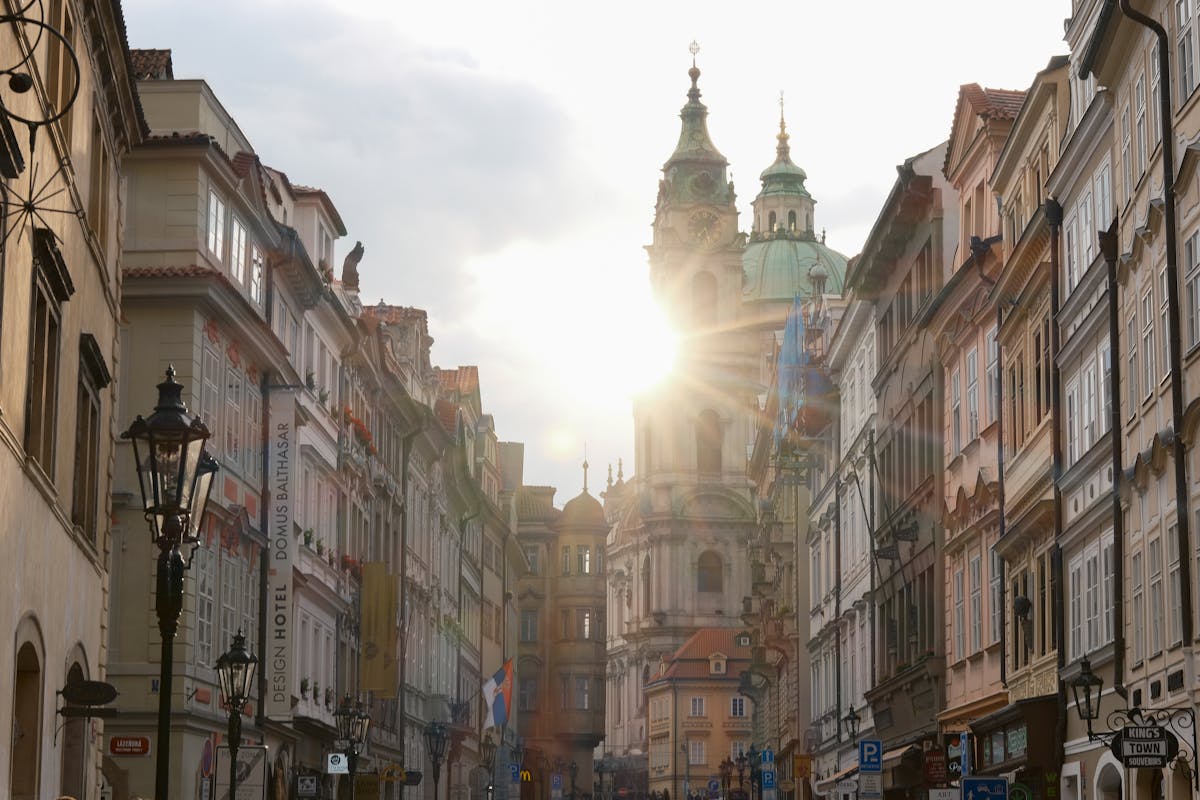 Captivating Prague street view with sunlight over historic buildings and Prague Castle