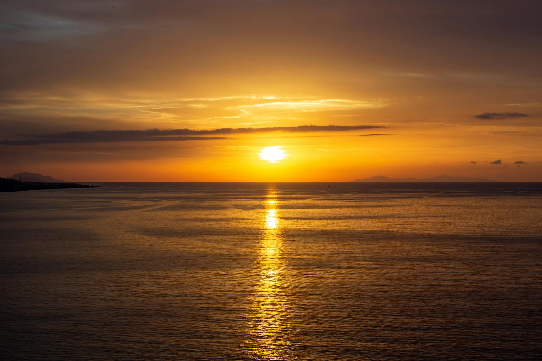 Warm sunset reflected on a calm sea surface