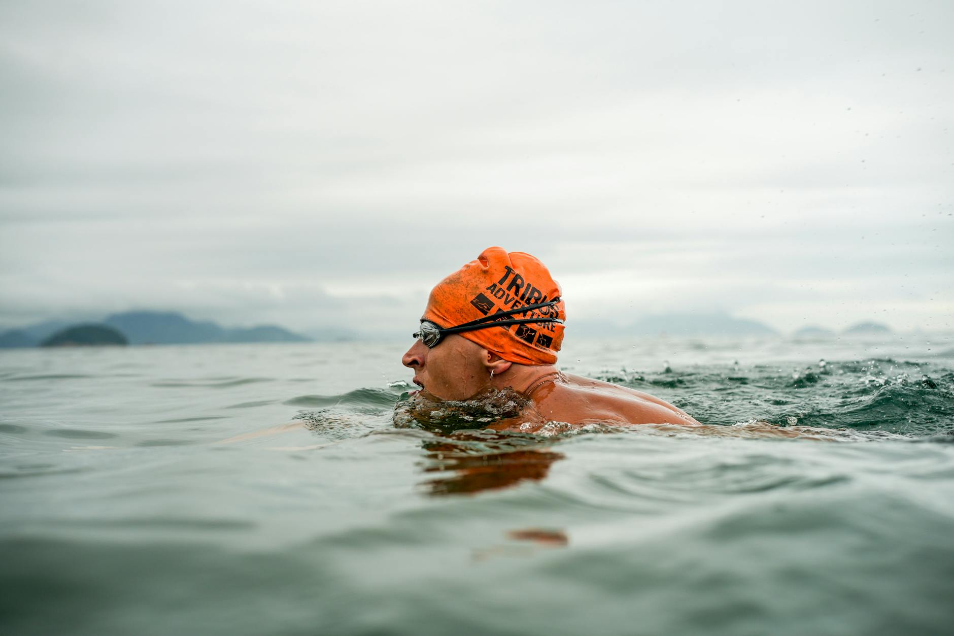 Person swimming in the clear blue open water of the Mediterranean
