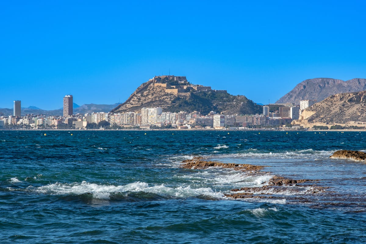 Scenic view of Alicante coastline with Santa Barbara Castle on hilltop