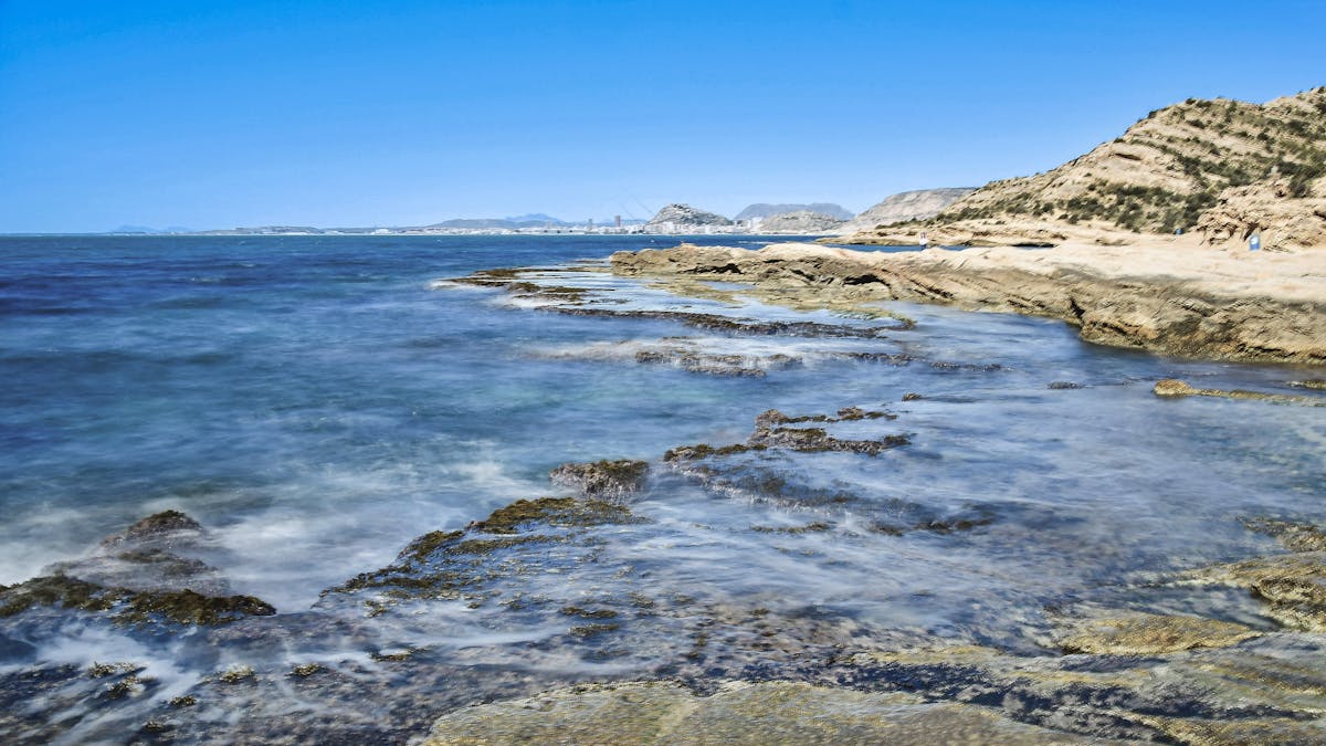 Rocky Mediterranean shoreline with clear blue water near Alicante Spain