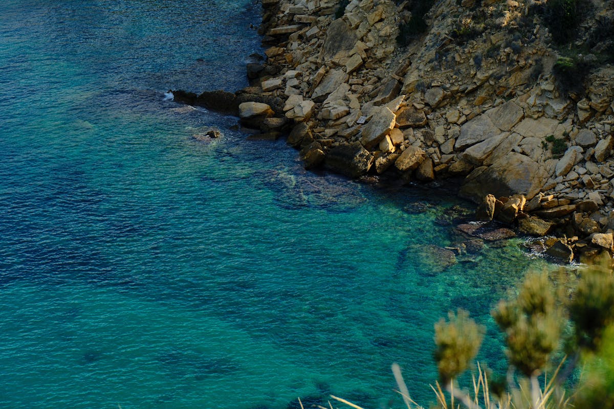 Rocky coastline with crystal clear blue water at El Albir Costa Blanca Spain