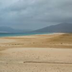 Wide sandy beach under cloudy skies in Tarifa Spain