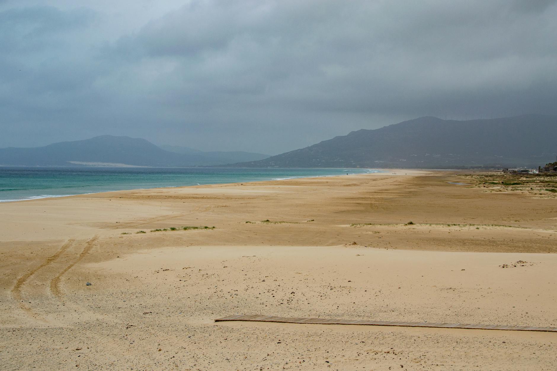 Wide sandy beach under cloudy skies in Tarifa Spain