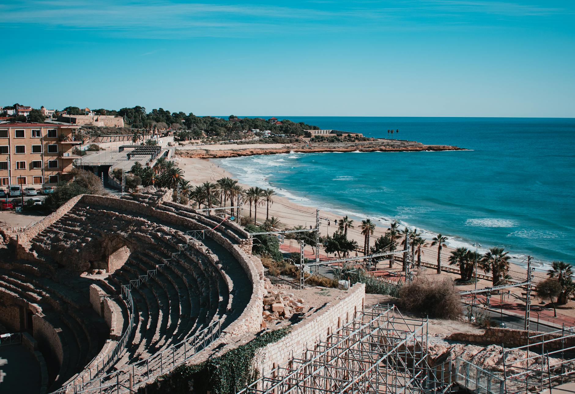View from a Tarragona balcony overlooking the Mediterranean coastline and red rooftops