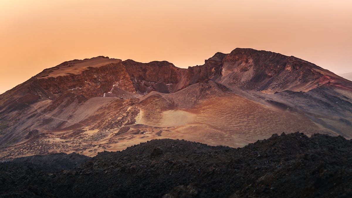 Mount Teide volcano against an orange sunset sky