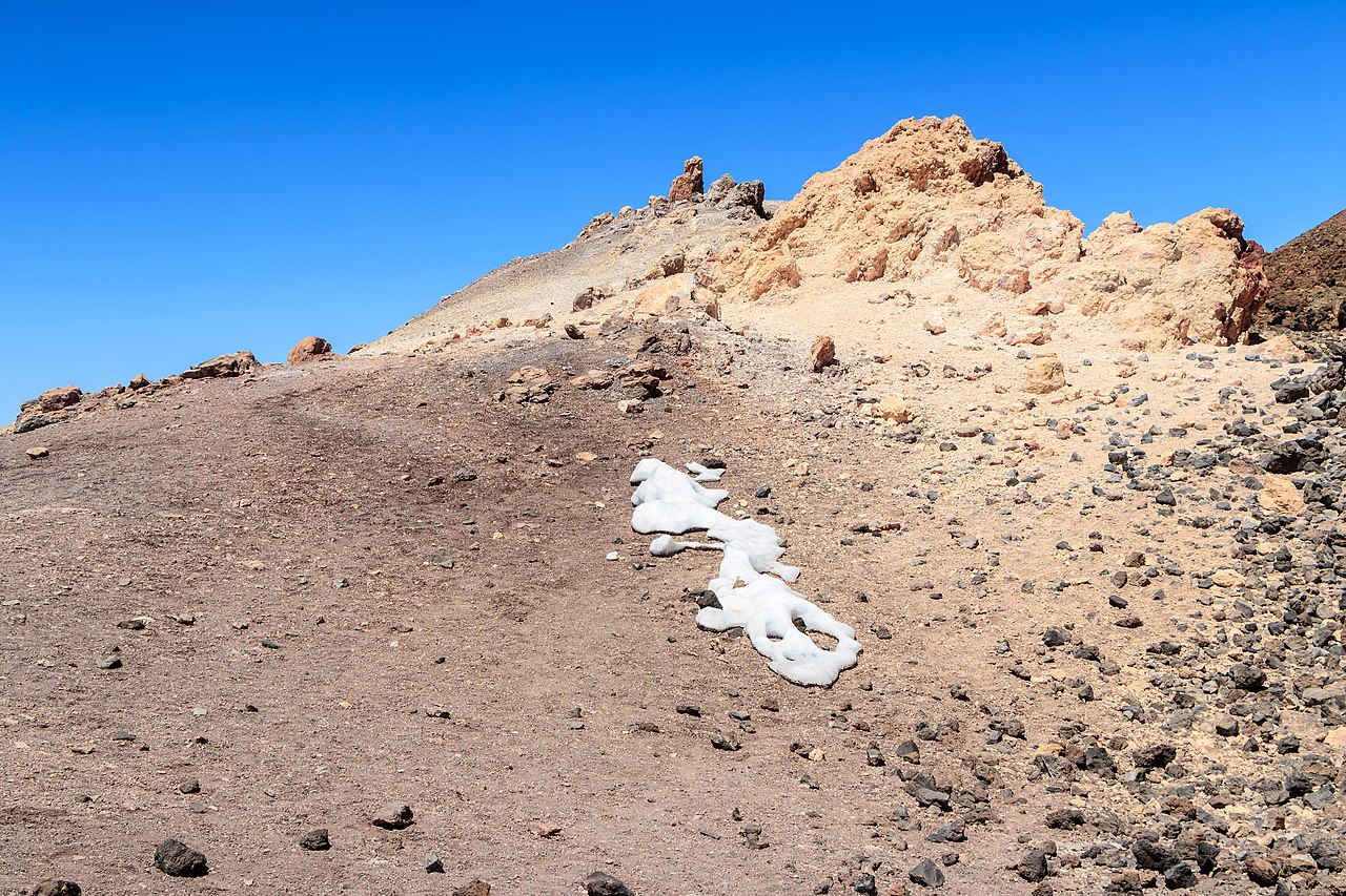 Mount Teide summit covered in snow against blue sky