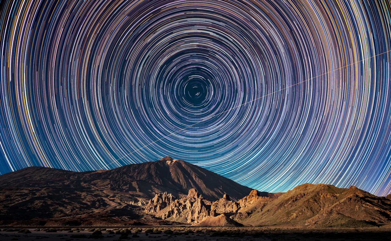 Long exposure star trails circling above Mount Teide at night