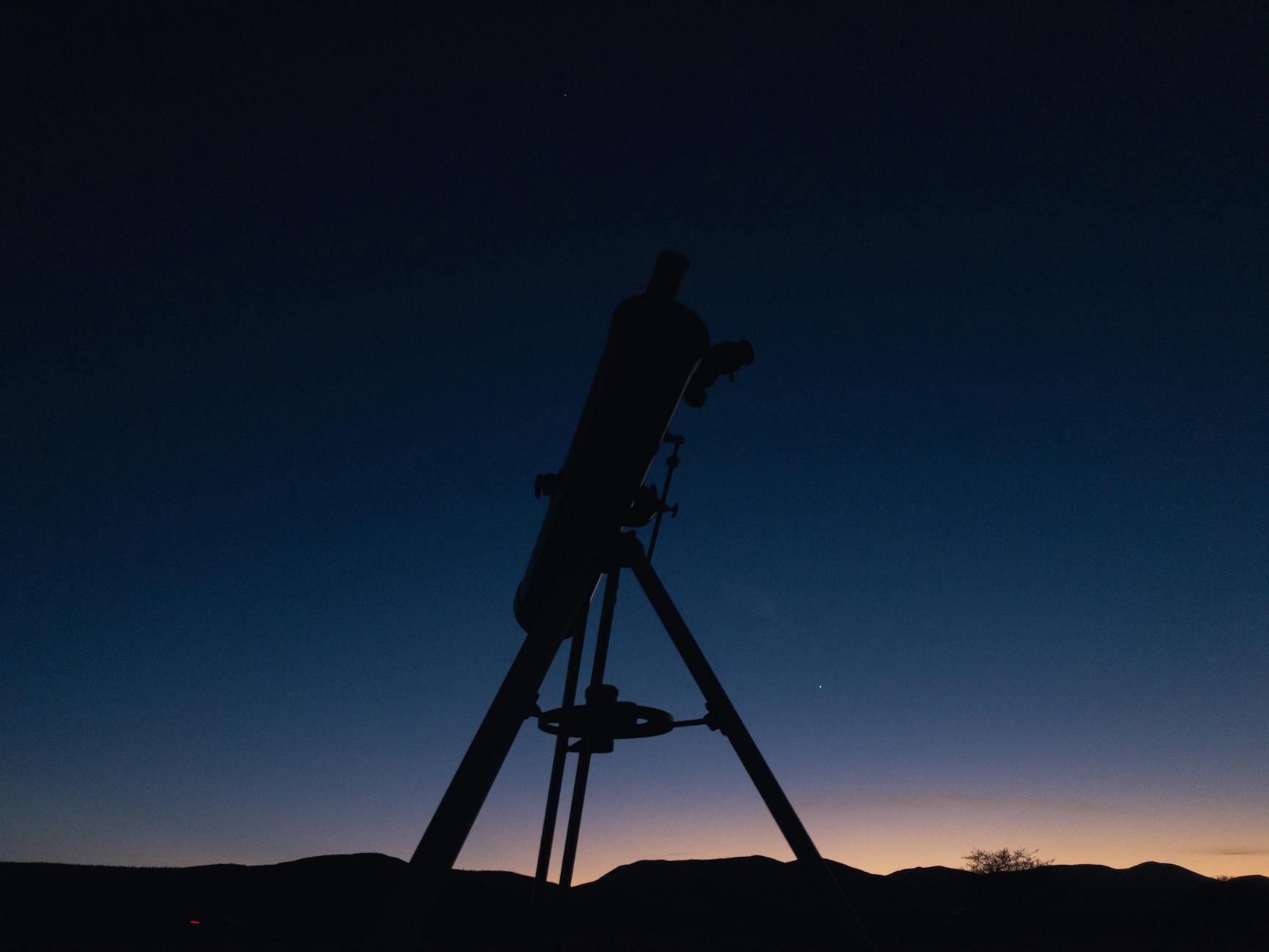 Telescope pointed at the night sky during stargazing tour