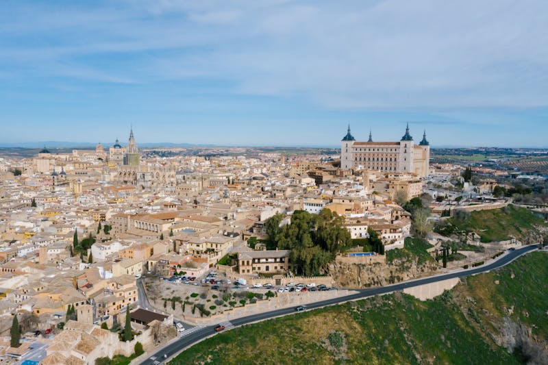 Aerial view of Toledo Spain showing the Alcazar fortress and cathedral among tightly packed medieval buildings