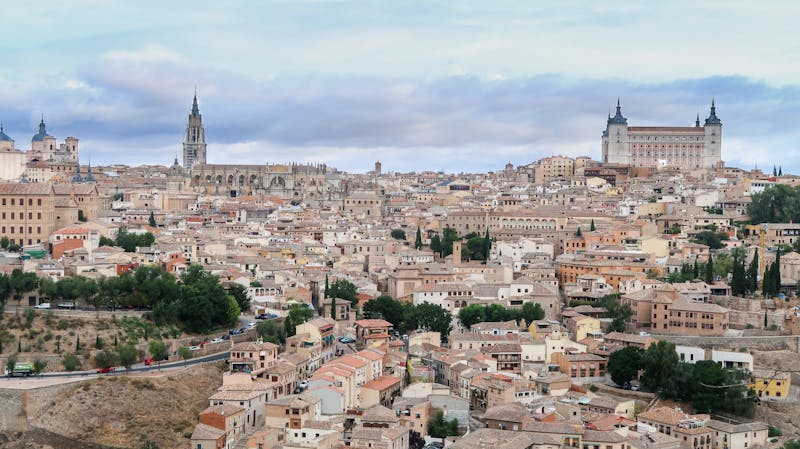 Aerial view of Toledo Spain showing dense medieval architecture and the Alcazar fortress