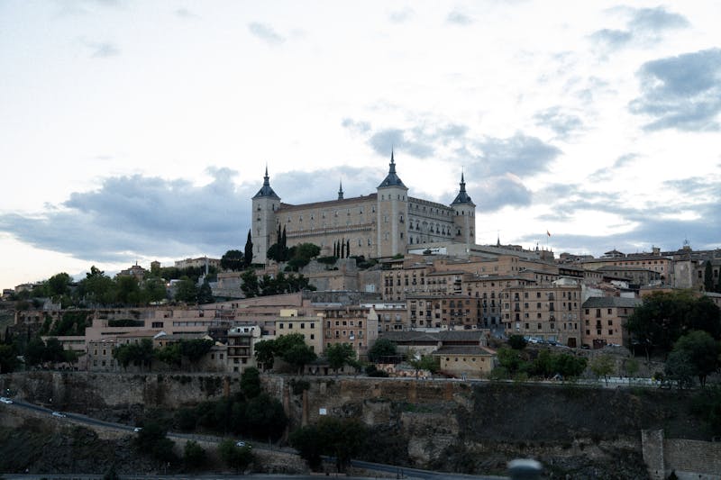 The Alcazar de Toledo silhouetted against a dusky sky