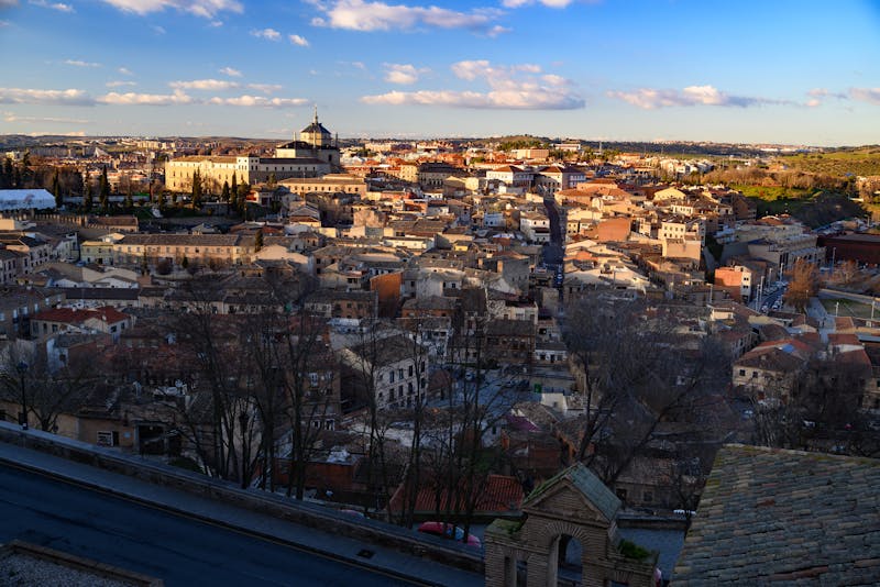Aerial view of Toledo Spain at dusk showing illuminated buildings and streets