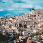 Panoramic view of Toledo skyline with the Alcazar rising above the medieval city and Tagus River below