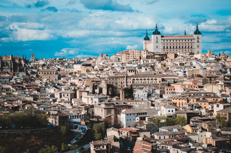 Panoramic view of Toledo skyline with the Alcazar rising above the medieval city and Tagus River below