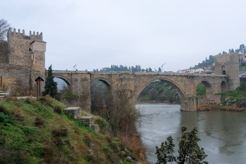 The medieval Puente de San Martin bridge over the Tagus River in Toledo Spain