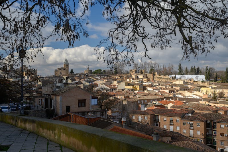 View over Toledo rooftops with the cathedral and historic buildings under clear sky