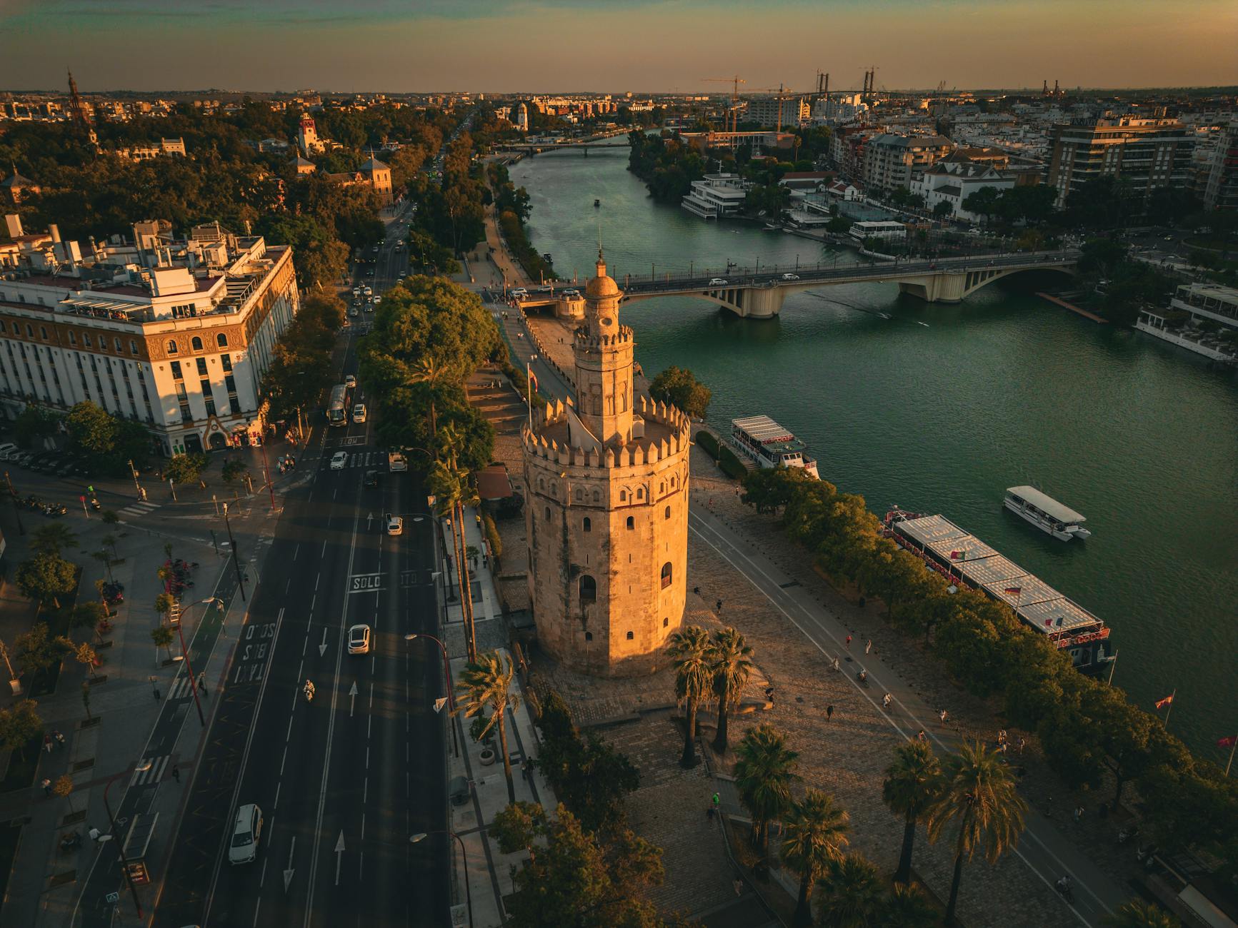 Torre del Oro tower beside the Guadalquivir River at sunset in Seville