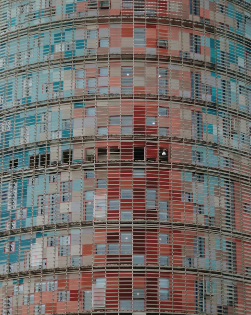Close-up of the colorful window details on the Torre Glories facade in Barcelona