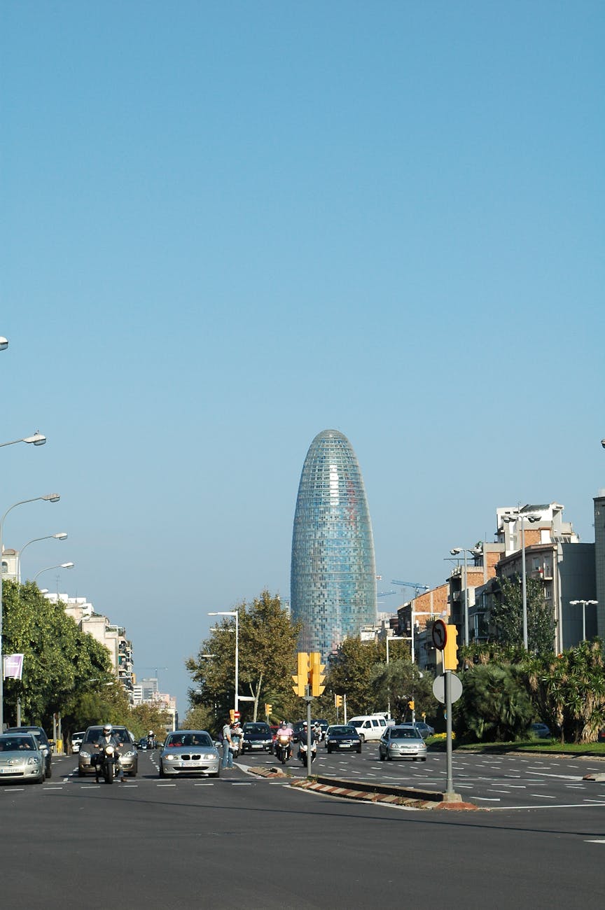 The distinctive Torre Glories building standing tall against a clear Barcelona sky