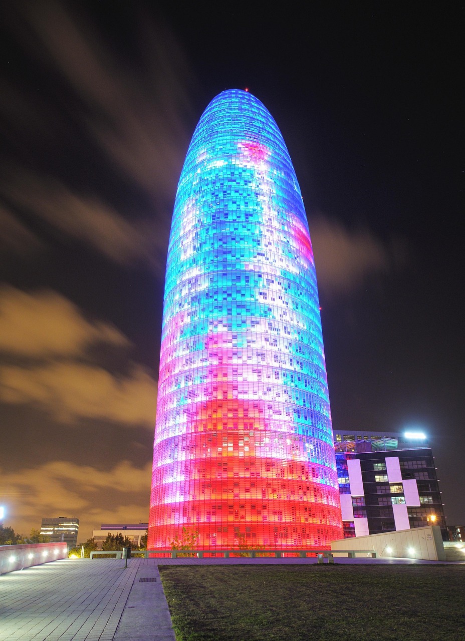 Long exposure night photograph of Torre Glories illuminated in Barcelona