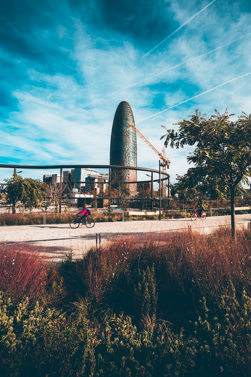 Street-level view of Torre Glories amidst Barcelona urban landscape