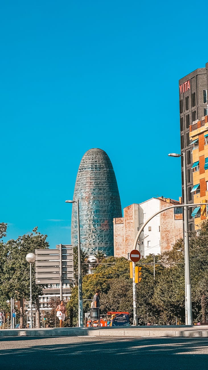Torre Glories surrounded by modern Barcelona urban architecture in daylight