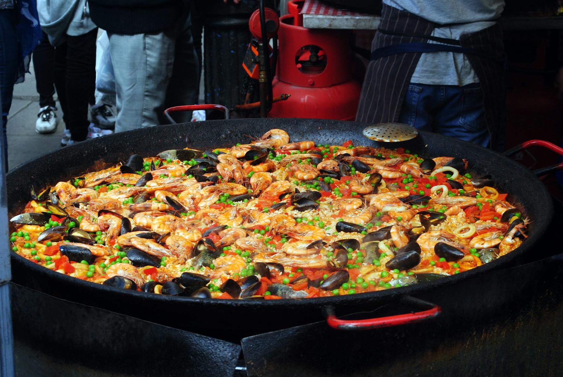 Top-down view of traditional Spanish paella with rice and chopped vegetables in a pan
