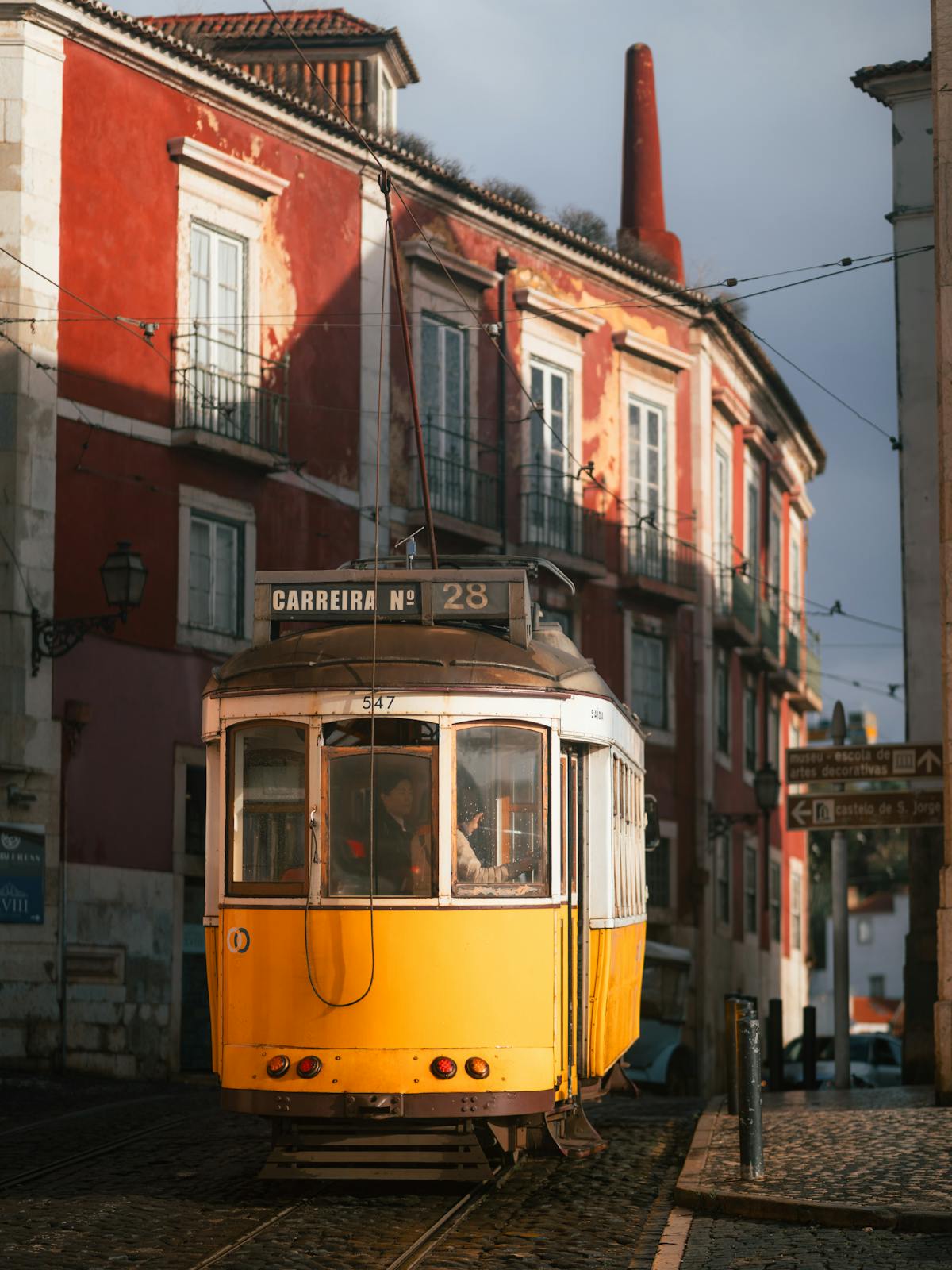 Historic Tram 28 rolling through Lisbon old districts past traditional buildings